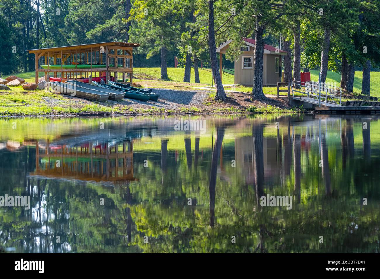 Still water reflections in the early morning light at the boat ramp on ...