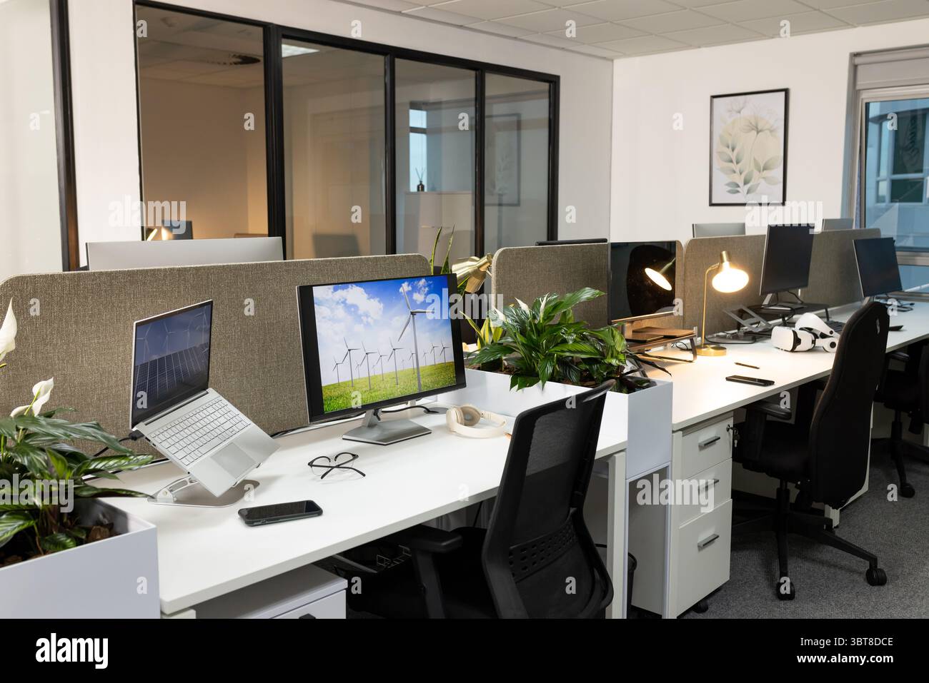 Workstation featuring laptop and monitor displaying wind turbines, with ...