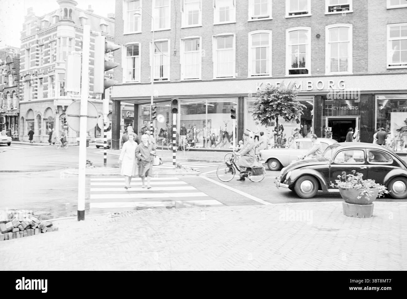 Woman in dress walking bicycle Black and White Stock Photos & Images ...