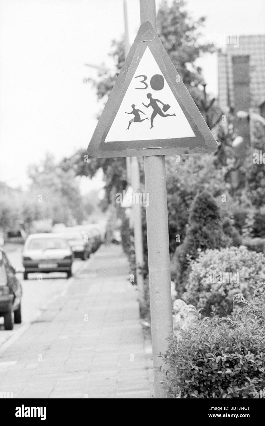 Triangular warning sign children crossing Black and White Stock Photos ...