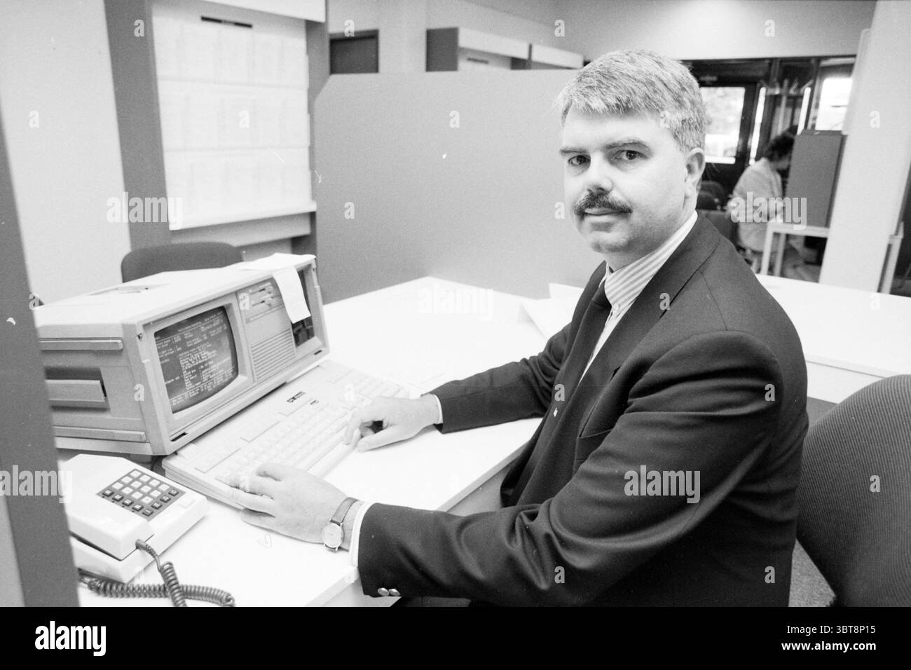 Man behind desk with computer, Whizgle News, Dutch Desk, The ...