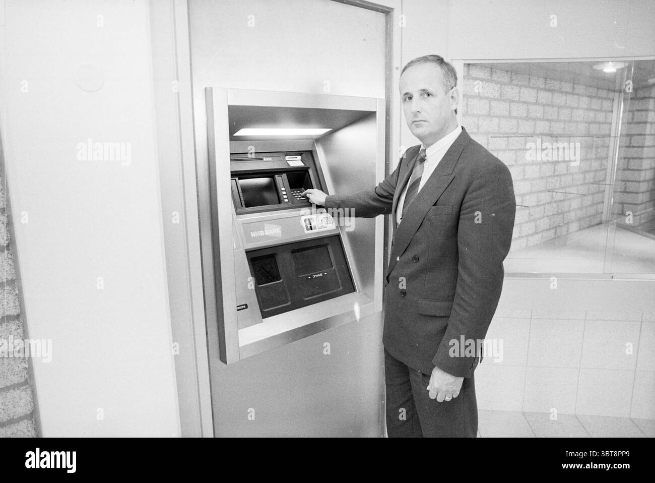 Portrait of man uses ATM, Whizgle News, Dutch Desk, The Netherlands ...
