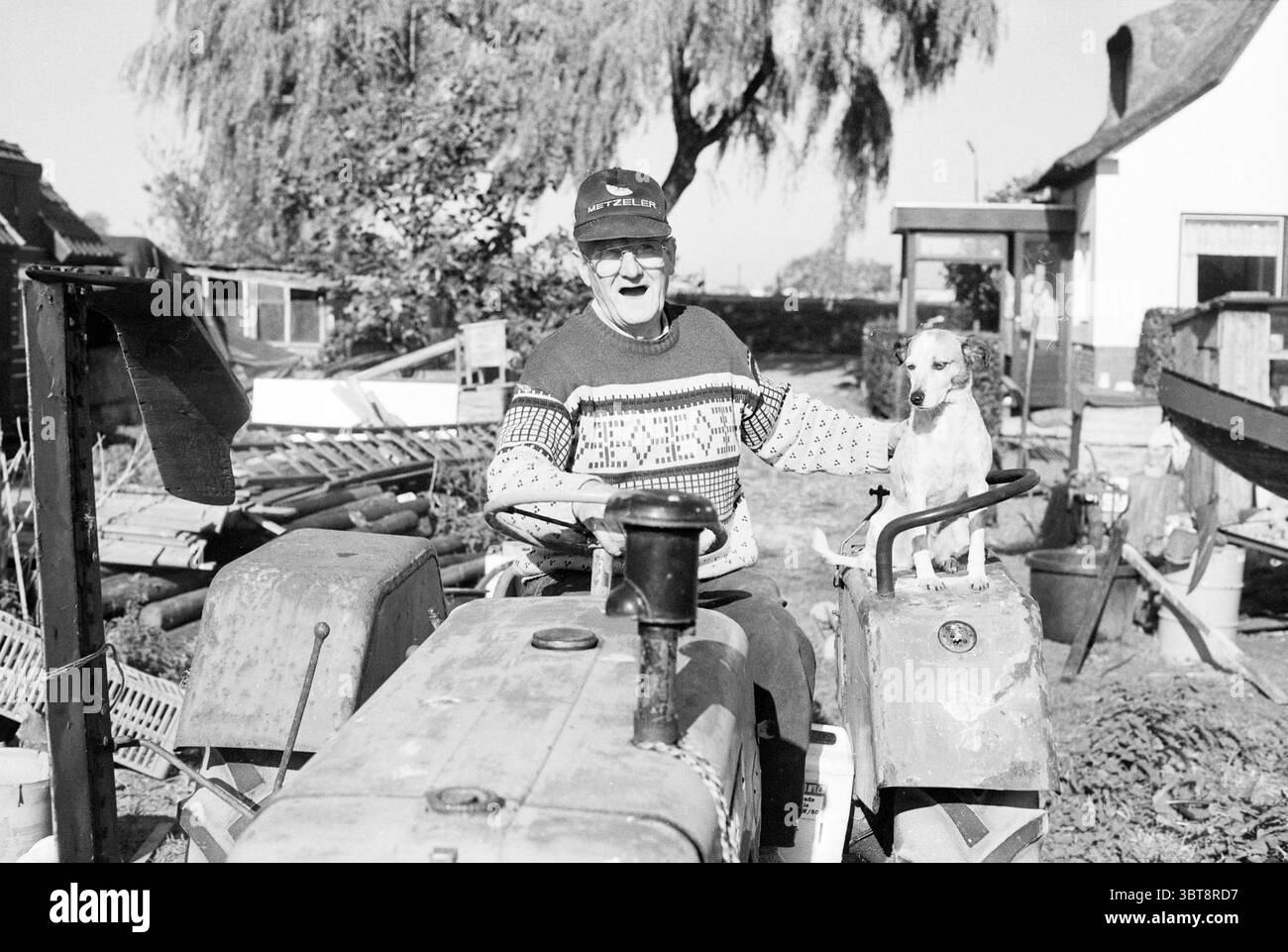 Man sits on small tractor hi-res stock photography and images - Alamy