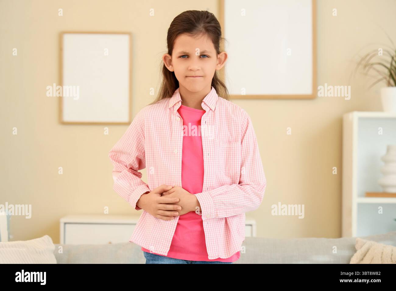Teenage girl with appendicitis at home Stock Photo - Alamy