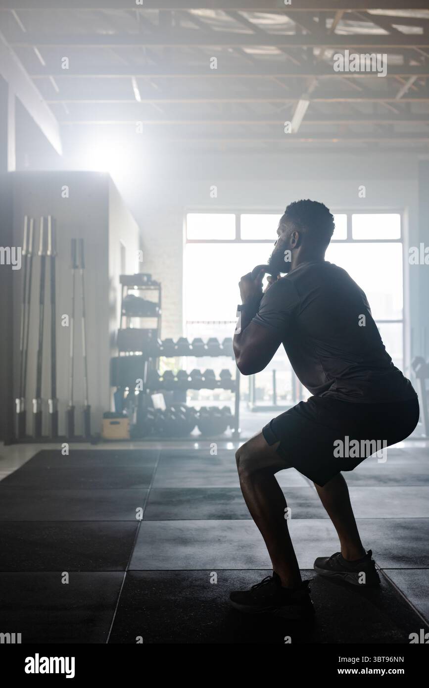 Man squatting weight in hands hi-res stock photography and images - Alamy