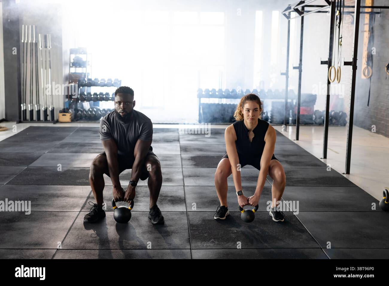 Fitness partners holding squat hi-res stock photography and images - Alamy