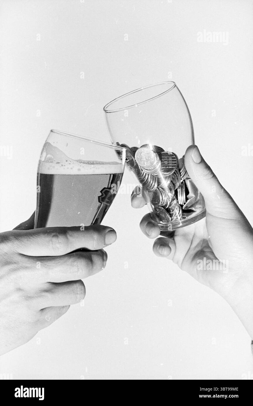 Coins clinking Black and White Stock Photos & Images - Alamy