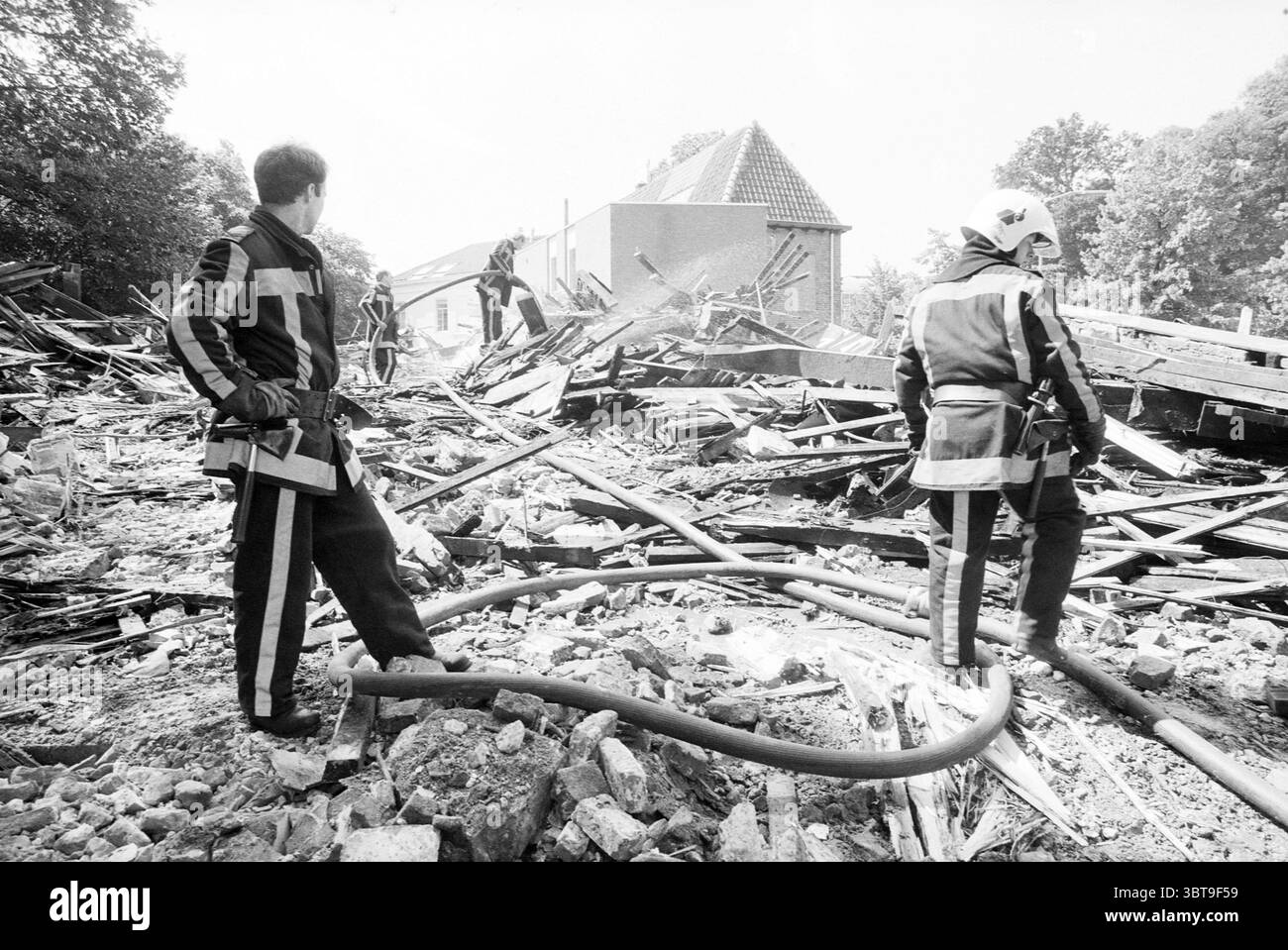 Two uniformed firefighters stand hi-res stock photography and images ...