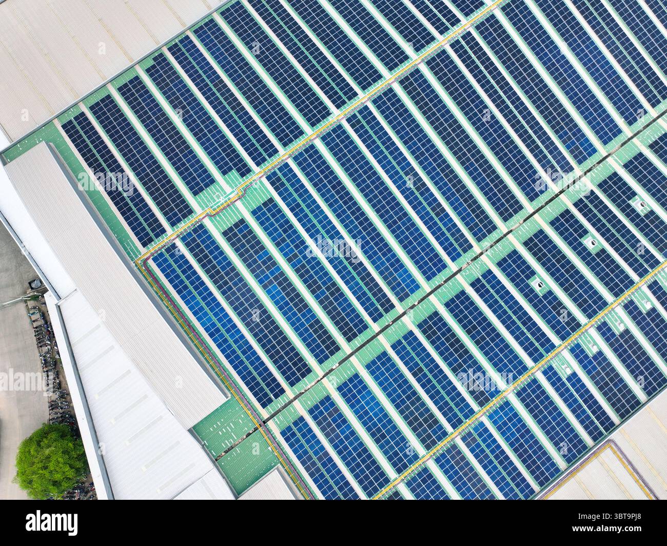Solar panels on industrial factory rooftop. Renewable energy ...
