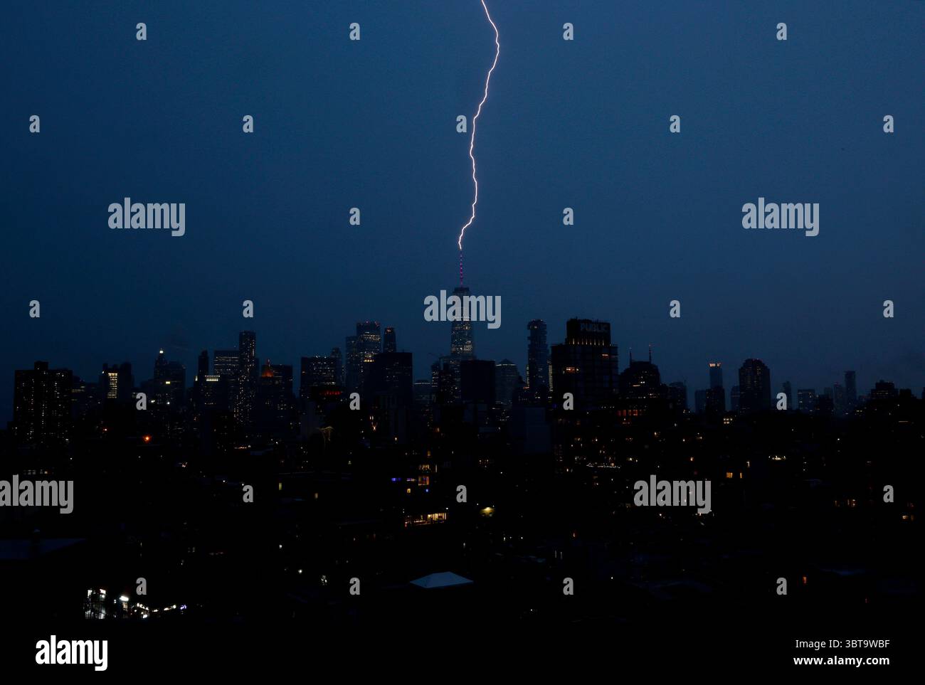 A bolt of lightning strikes the spire of One World Trade Center in the ...