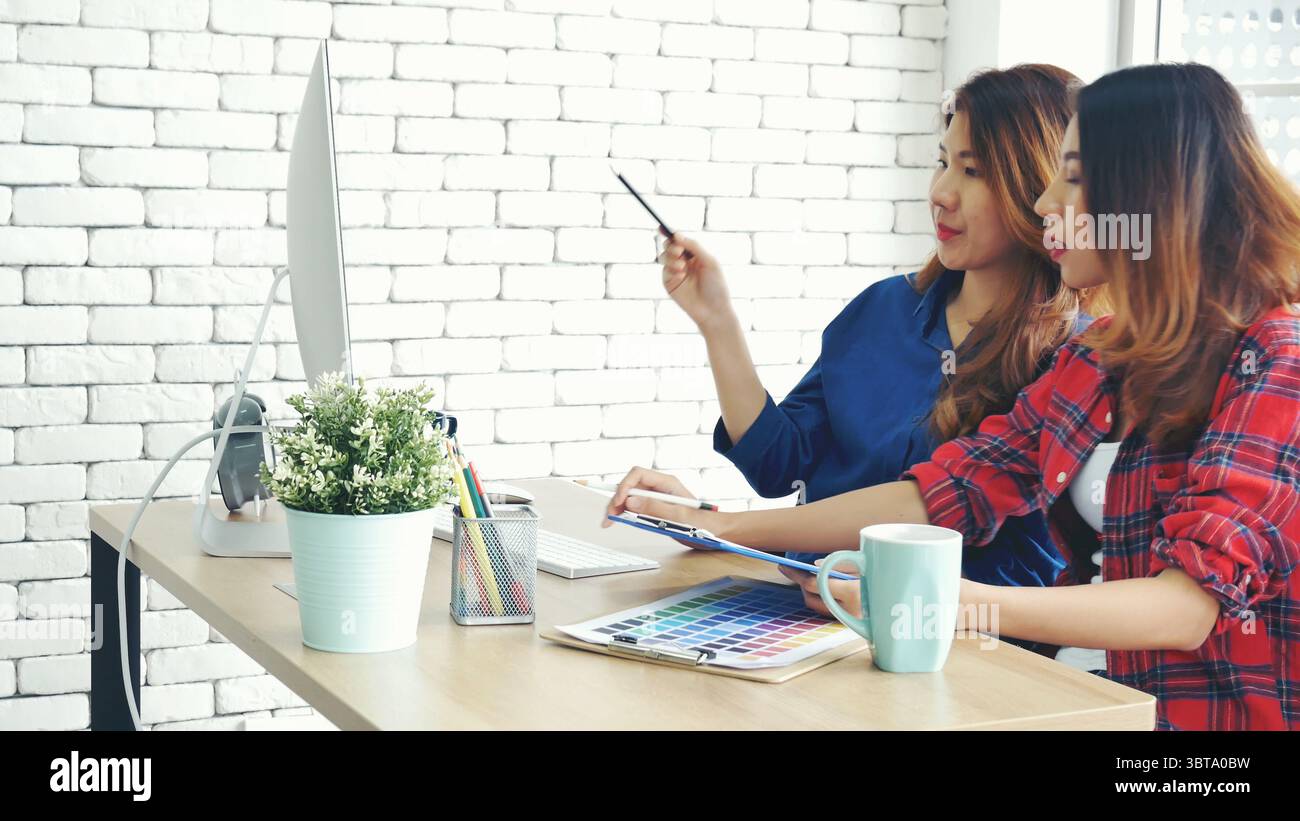 Asian colleague friendship at work with smiling face. Happiness two ...