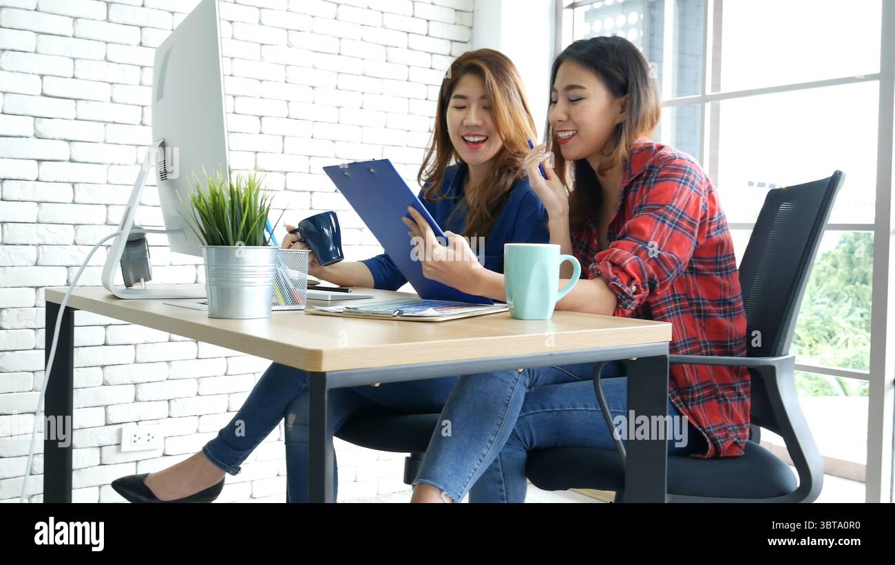 Asian colleague friendship at work with smiling face. Happiness two ...