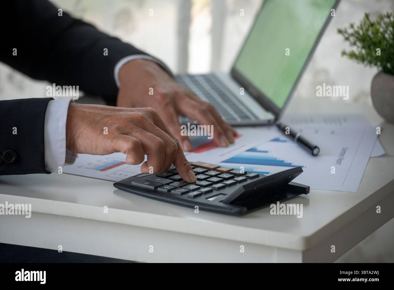Close up Man hands calculating number, data, graph, chart audit ...