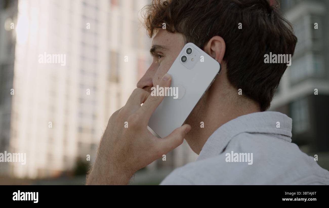 Back view close up head unrecognizable unknown man talking mobile phone ...
