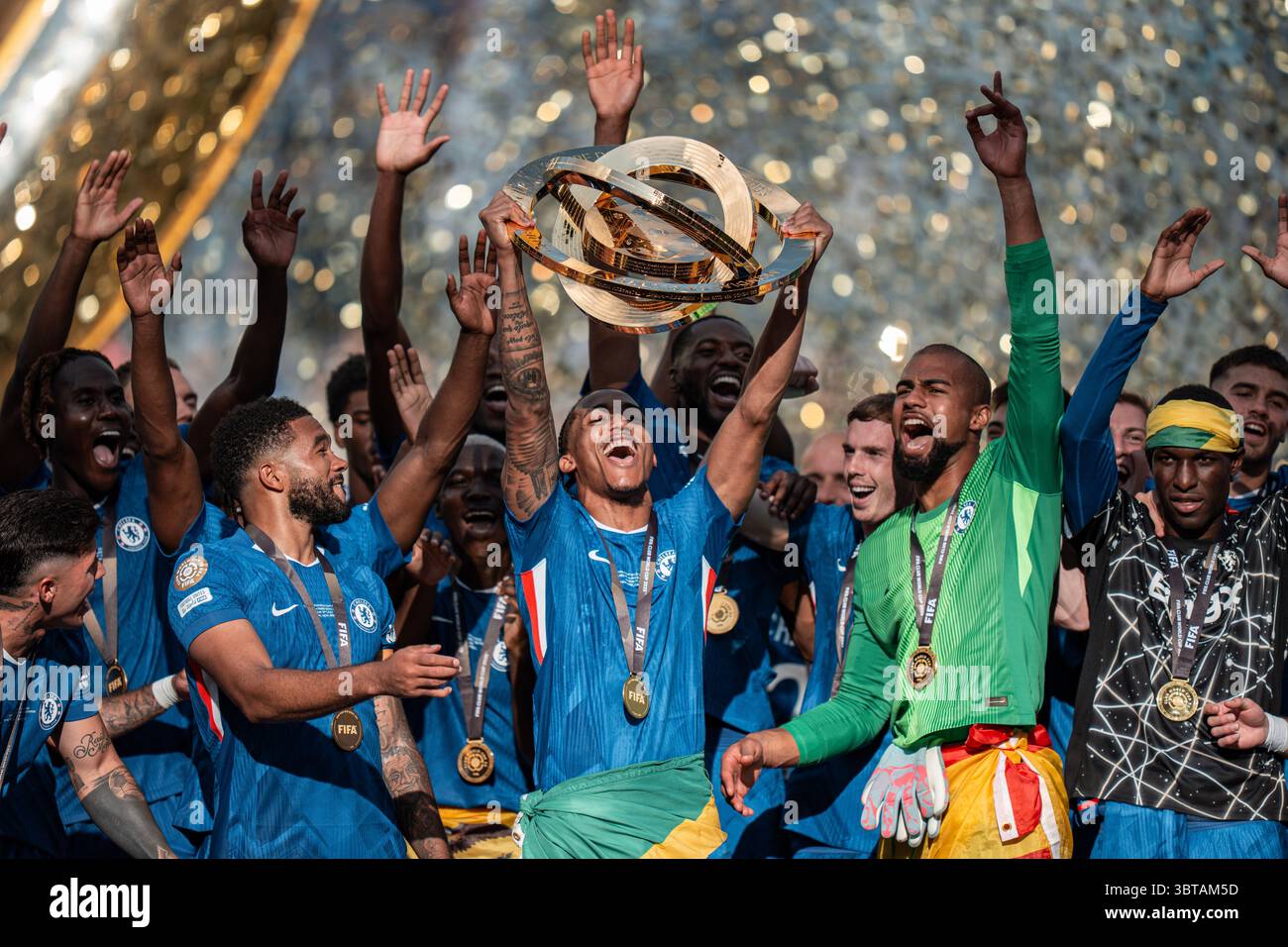 Chelsea forward João Pedro (20) lifts the trophy after winning the 2025 ...
