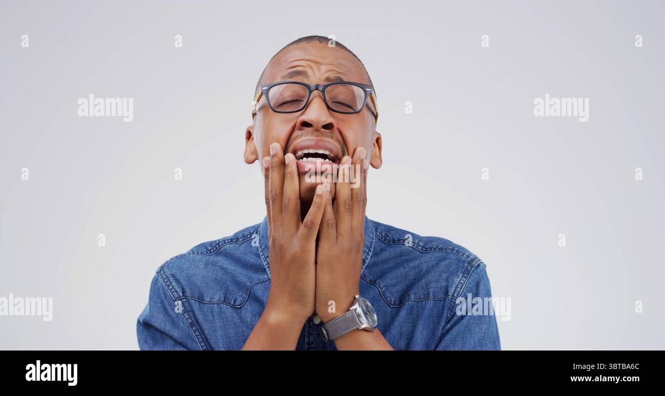 Emotional, black man and crying with grief in studio for bad news ...