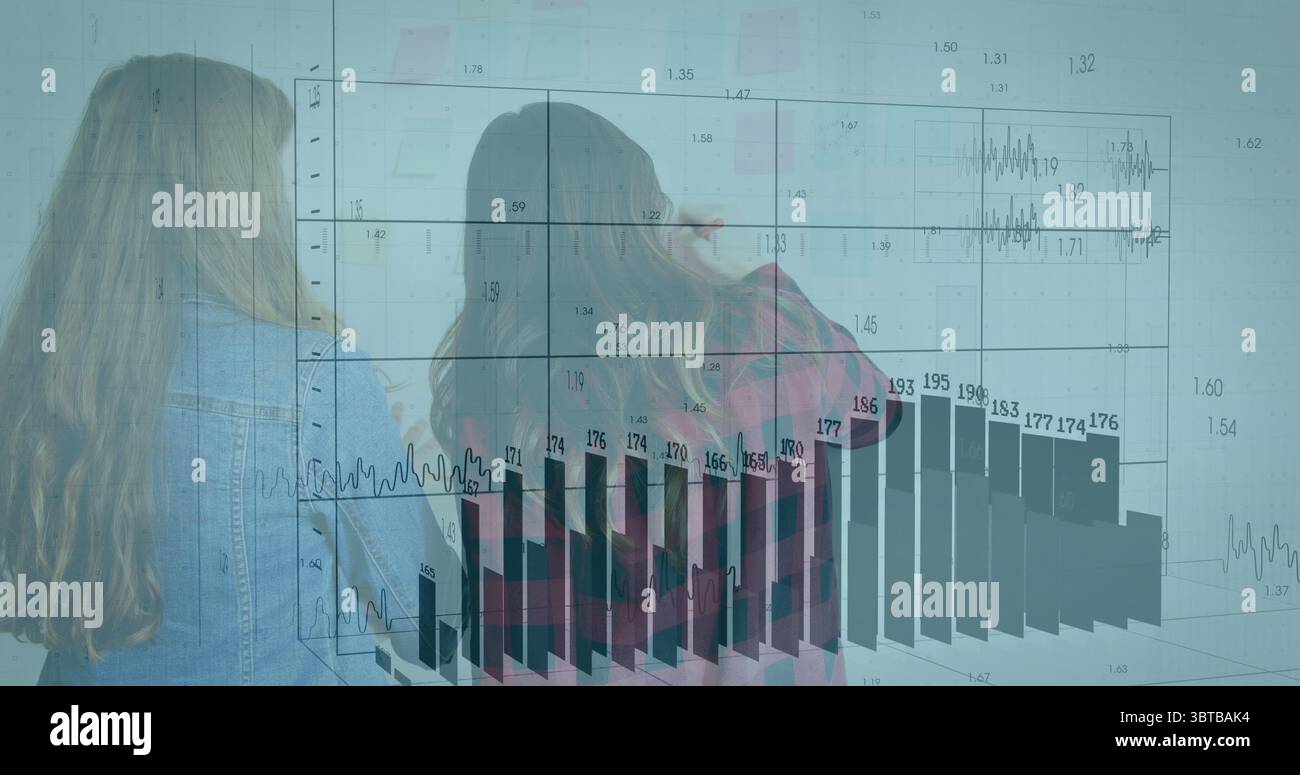 Analyzing projected charts women wearing denim jacket working in office ...