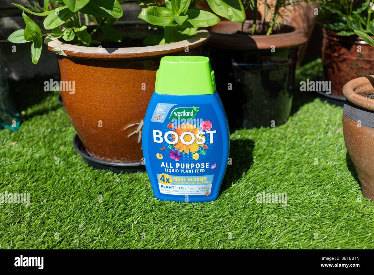 A plastic bottle of Boost all purpose liquid plant feed Stock Photo - Alamy