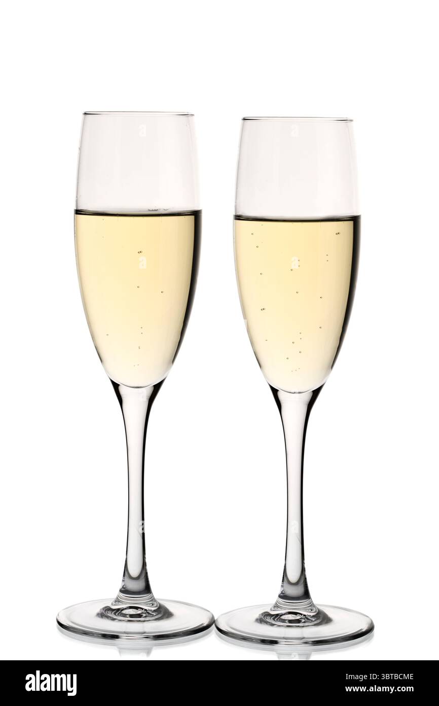 Two elegant champagne flutes filled with sparkling wine on clean white ...