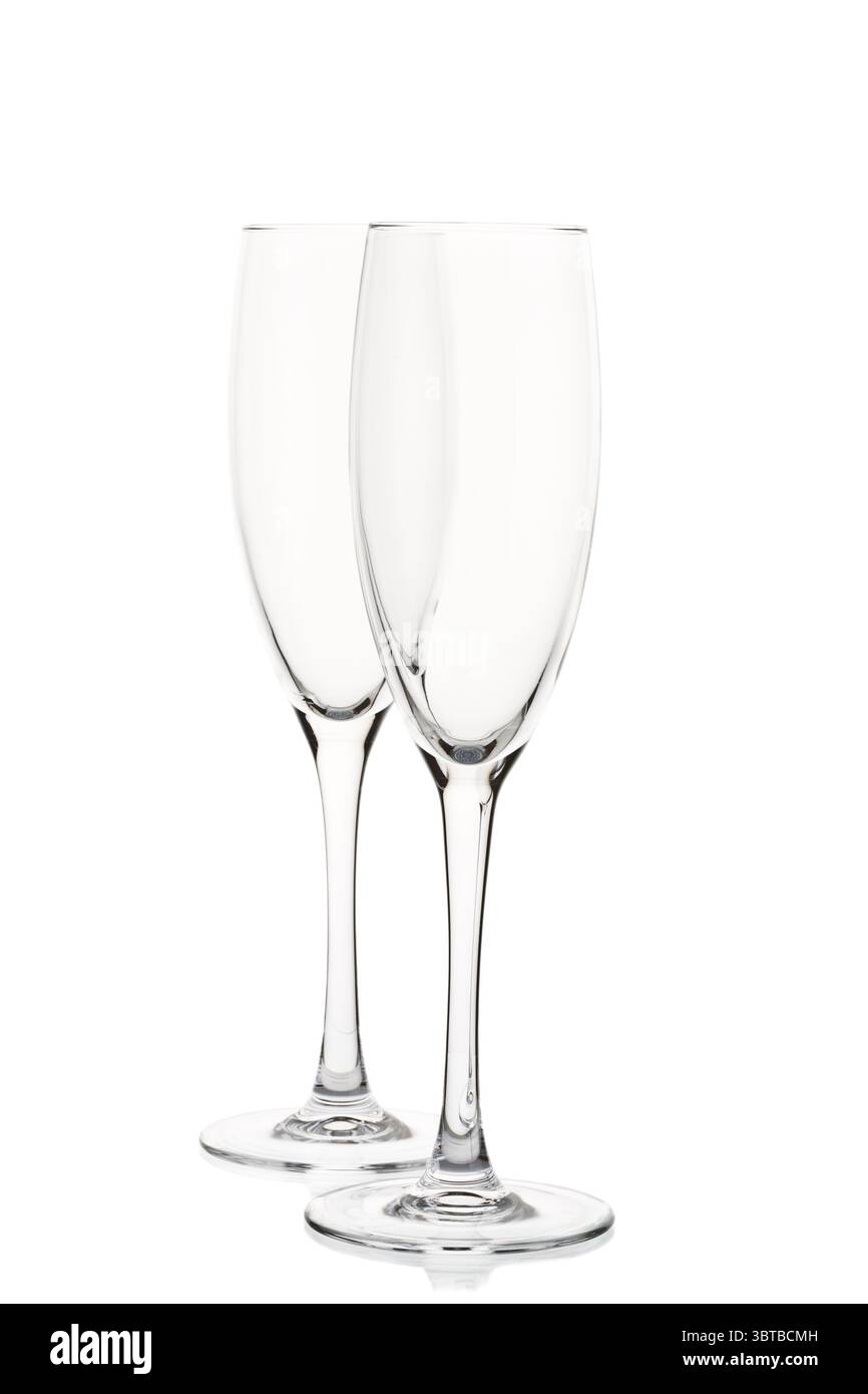 Two elegant empty champagne flutes on clean white background Stock ...