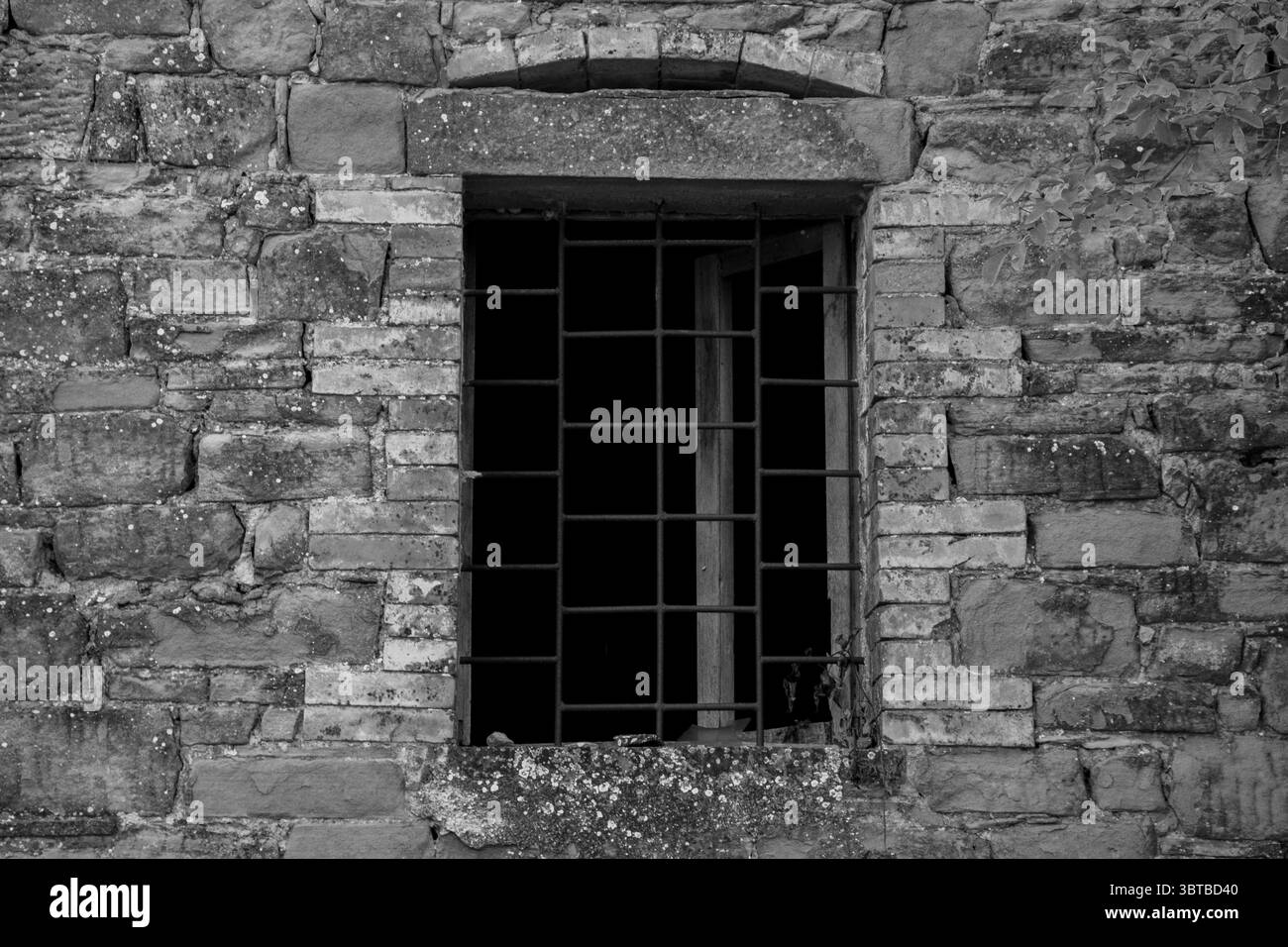 open vintage window with railing set in a stone wall of an ancient ...