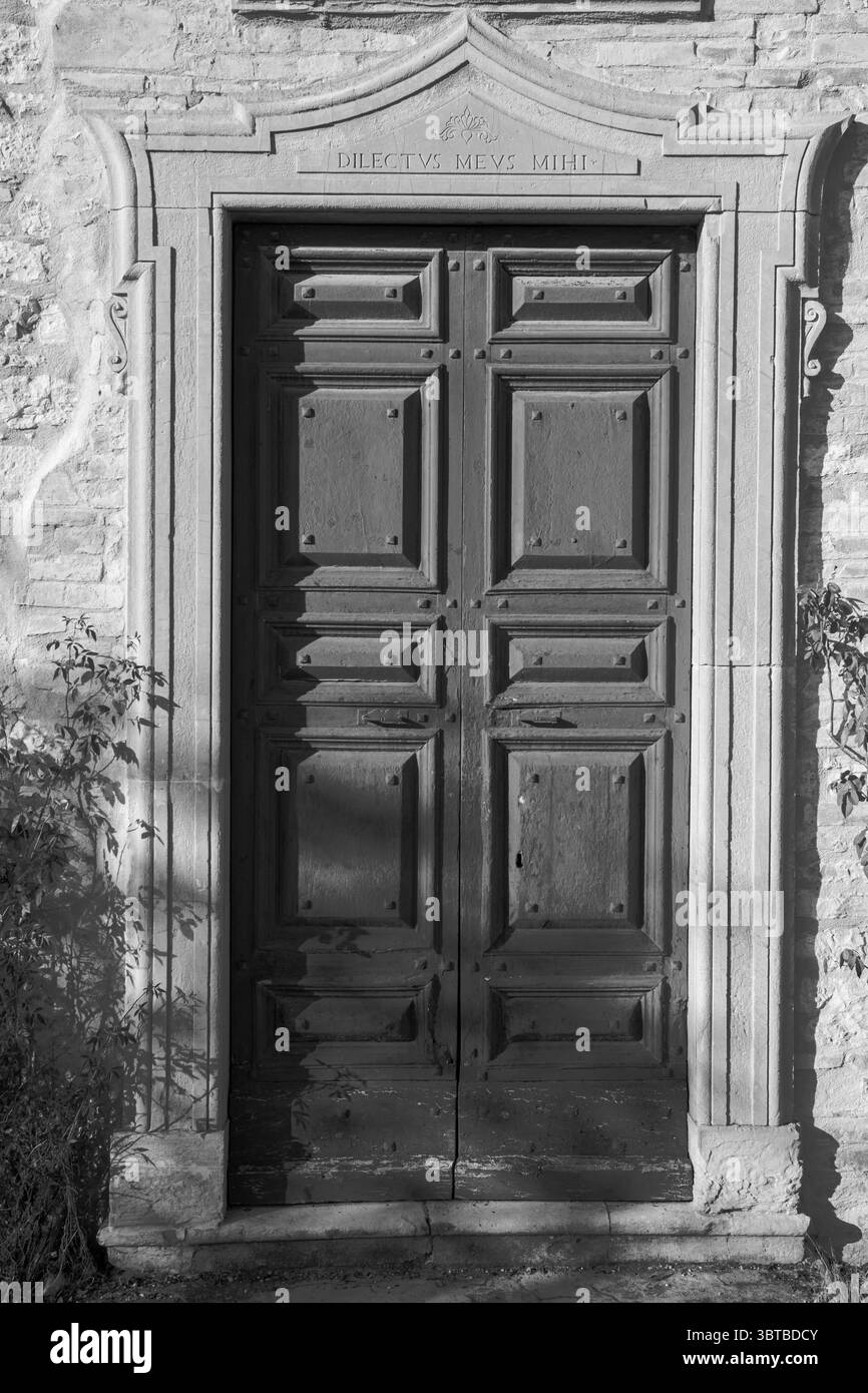 old wooden door set between ancient stone frame in black and white ...