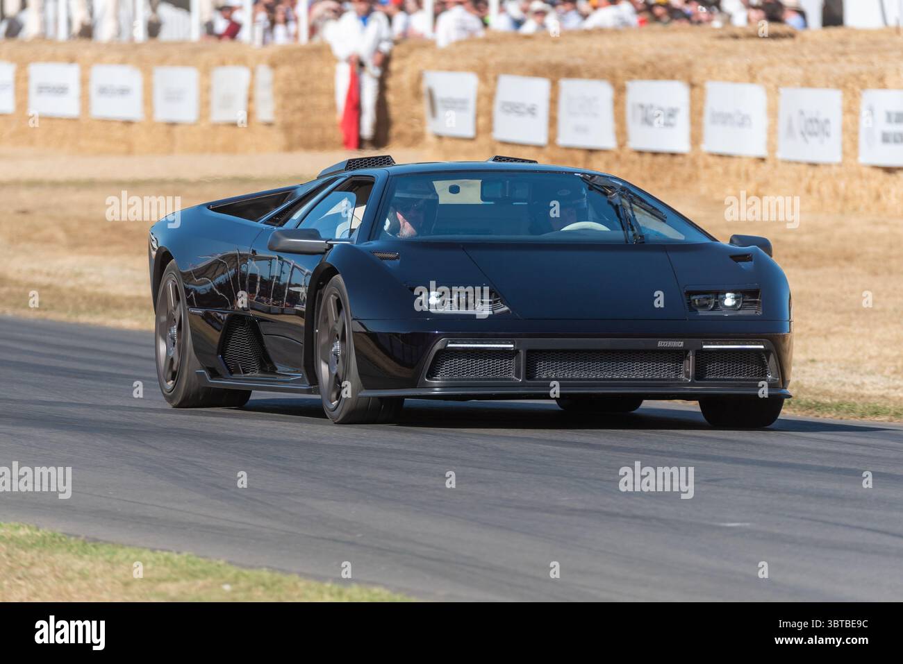 Eccentrica V12 sports car driving up the hillclimb track at the ...