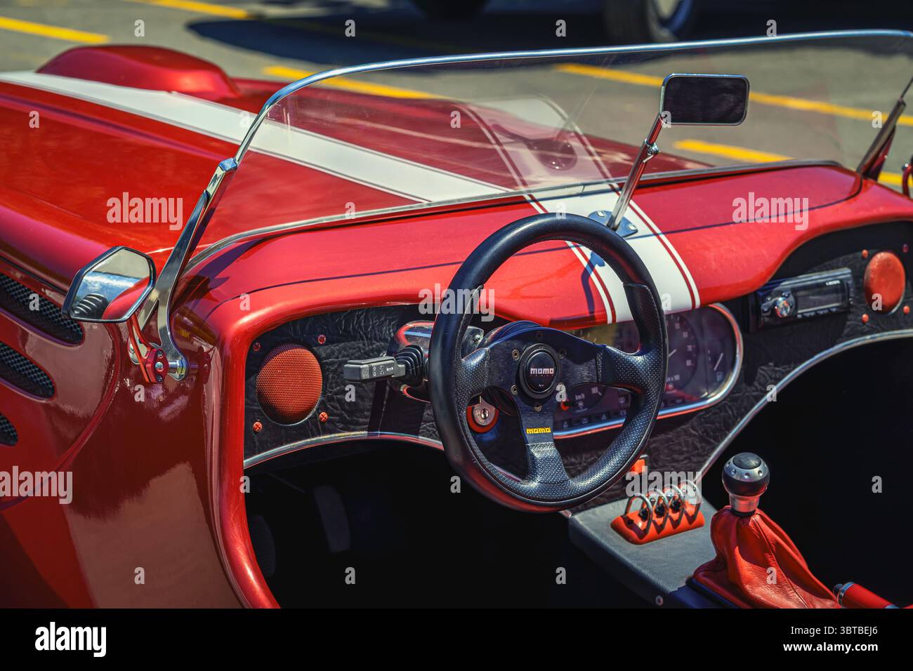 Red vintage dashboard with Momo wheel. Bright red dashboard with Momo ...