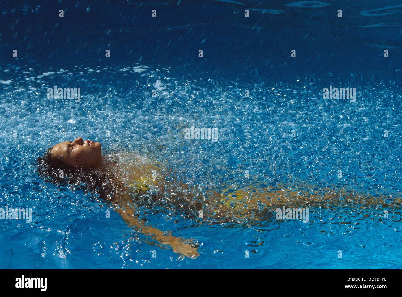 pretty young woman lay down in water sparkling water like jacuzzi well ...