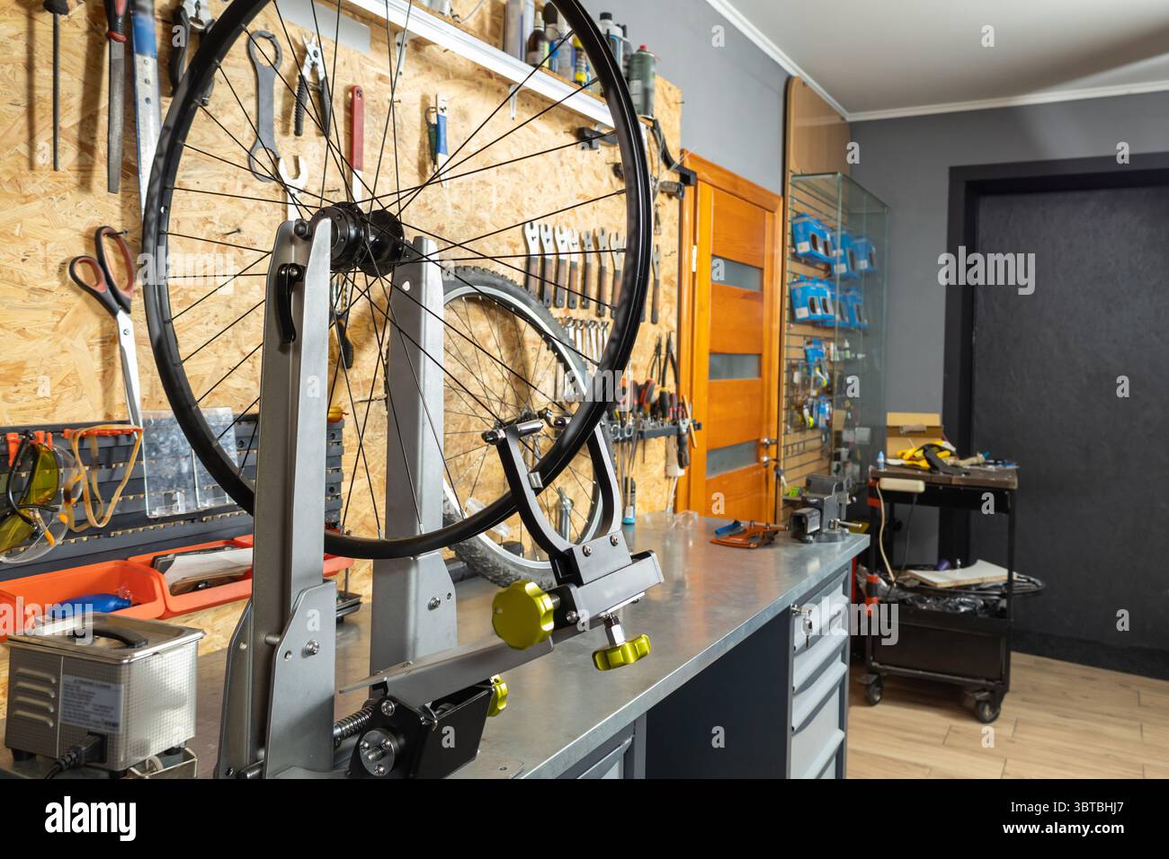 Bicycle wheel tuning station in workshop Stock Photo - Alamy