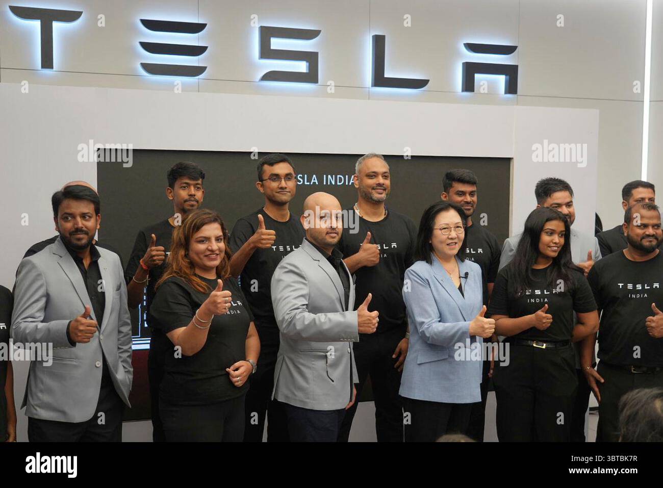 Tesla South East Asia director Isabelle Fan, third right, poses for a ...