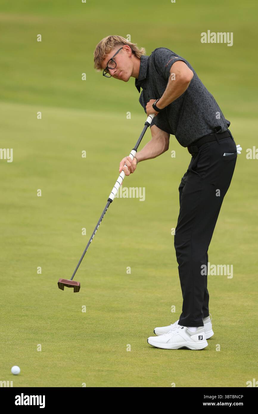 Richard Teder of Estonia putts on the 1st green during a practice round ...