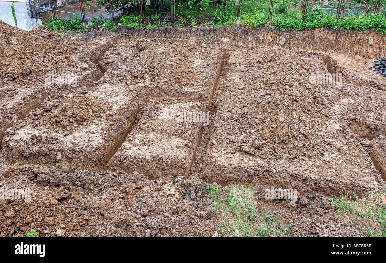Brown earth with dug trenches for a construction foundation Stock Photo ...