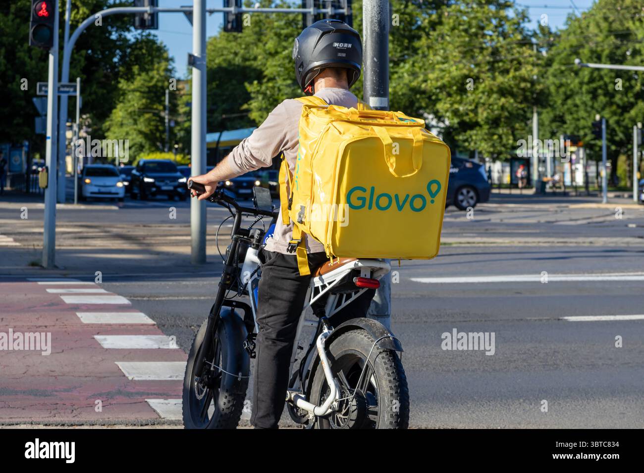 Poznan, Poland - June 30, 2025: A Glovo delivery courier on an e-bike ...