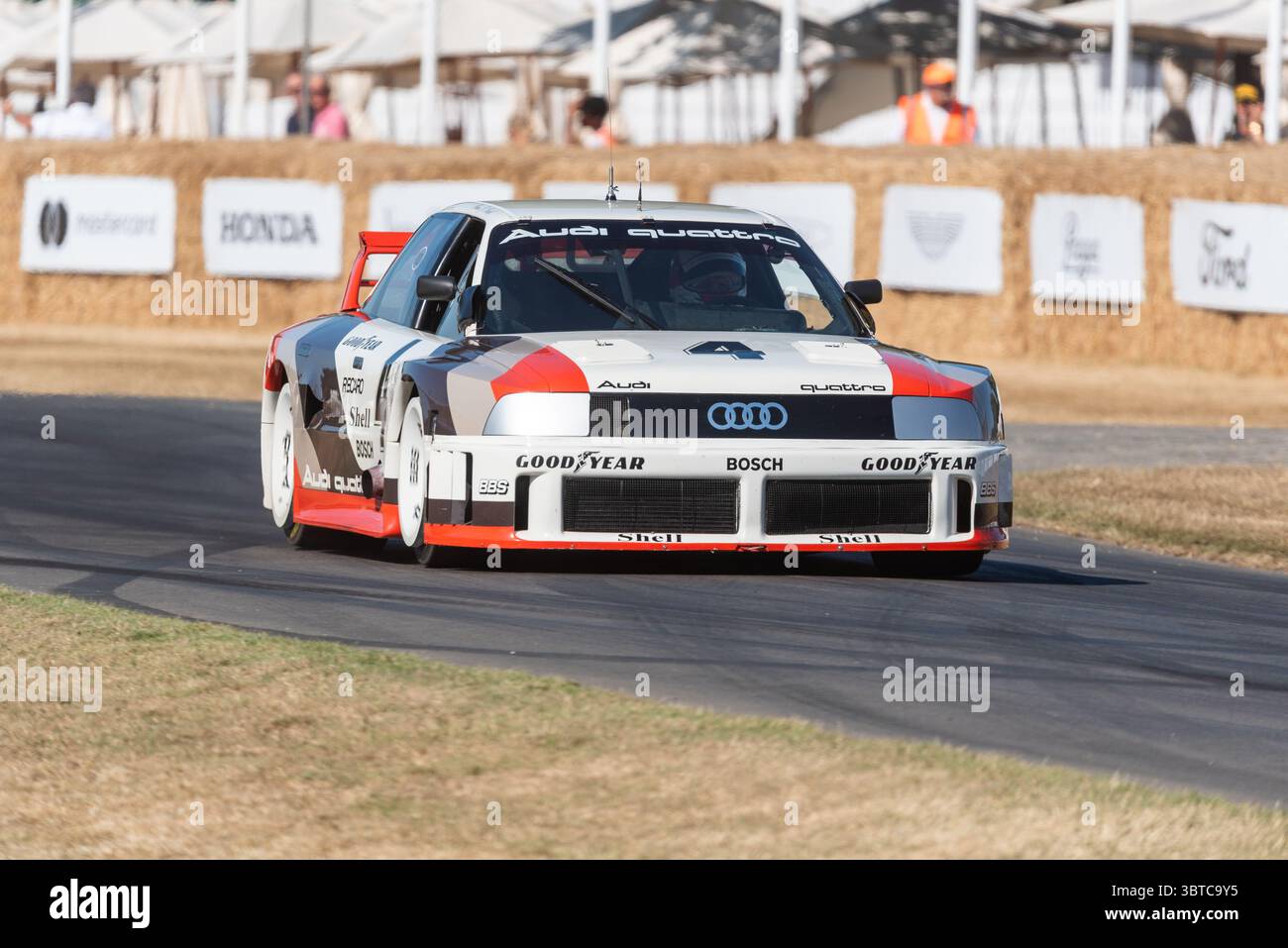 Audi 90 Quattro IMSA GTO race car driving up the hillclimb track at the ...