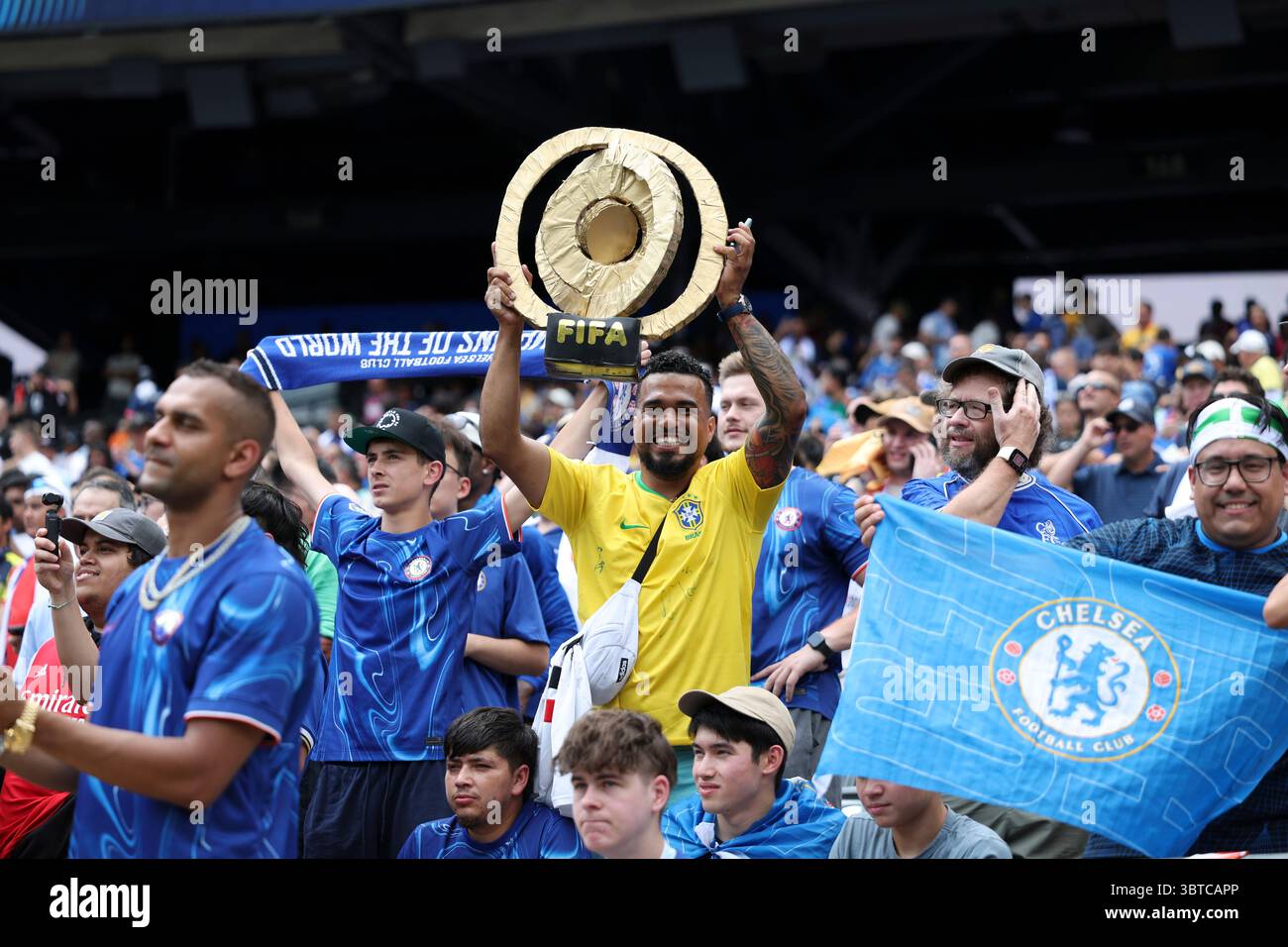 A Chelsea FC fan lifts a cardboard FIFA Club World Cup trophy during ...