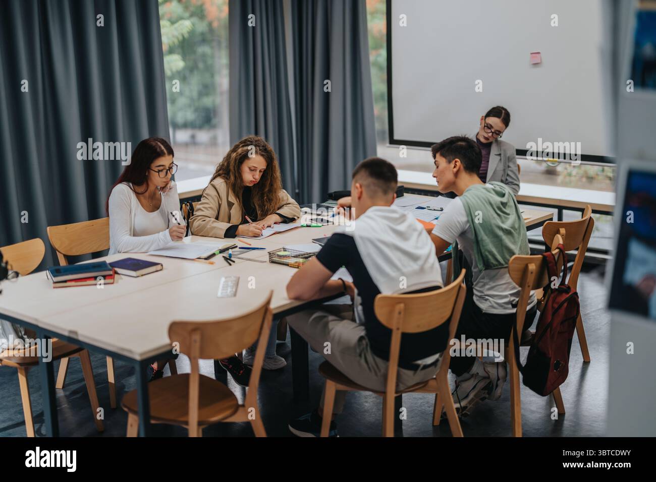 Students collaborating on a project in a modern classroom setting Stock ...