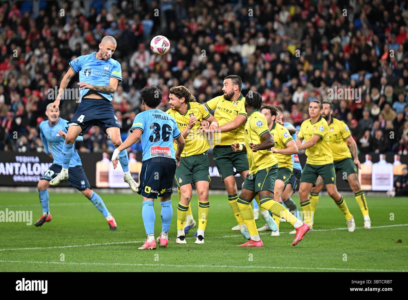 Jordan Courtney-Perkins of Sydney heads the ball setting up Alex ...