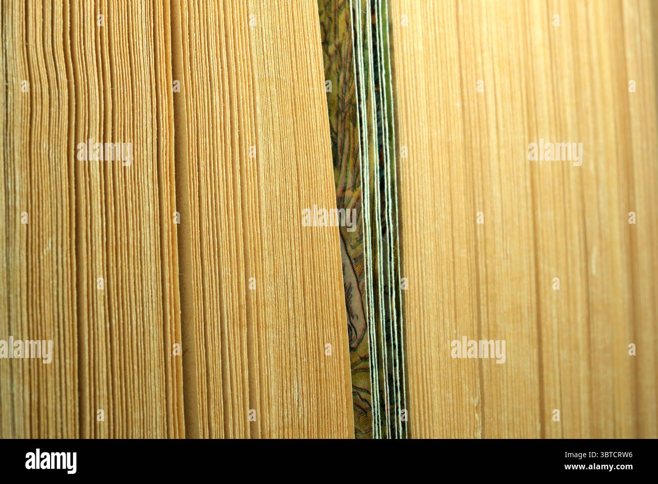 Abstract yellow background closed book end up on the table, education ...