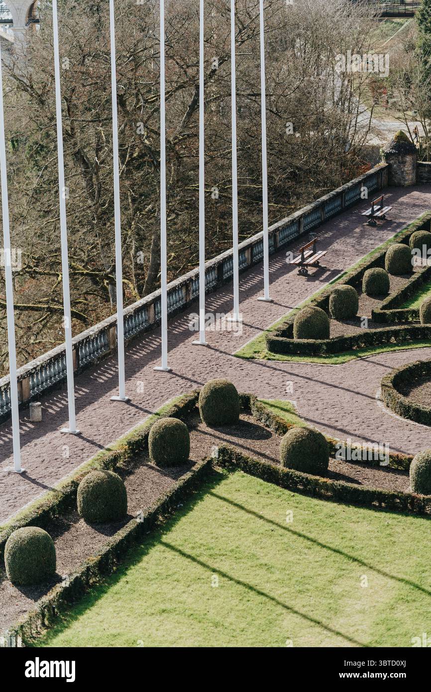 Elegant garden pathway with trimmed greenery and decorative hedges ...