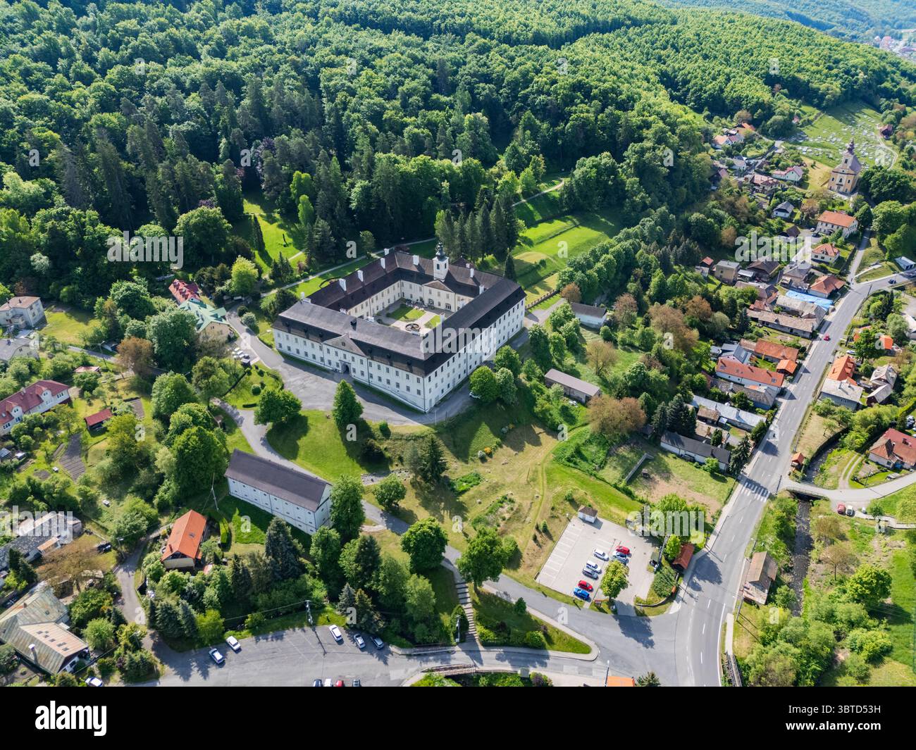 Aerial view of the grand, pale Svätý Anton Mansion nestled amidst ...