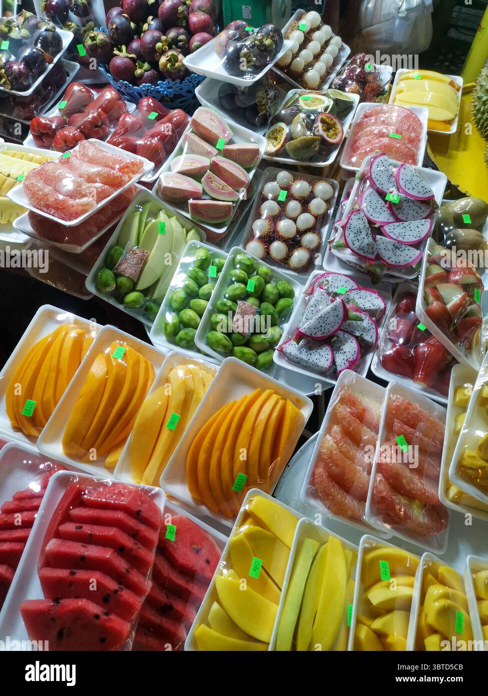 Fresh fruits in packing at market Stock Photo - Alamy