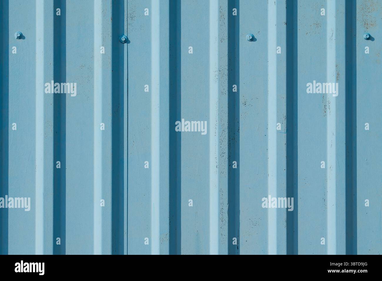 Blue corrugated metal wall with bolts. Abstract background with texture ...