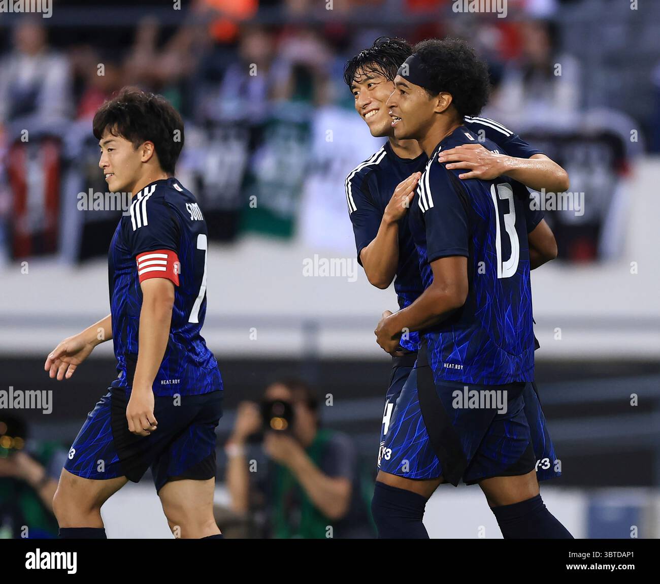 Ryo Germain of Japan (R) reacts after scoring the opening goal during ...