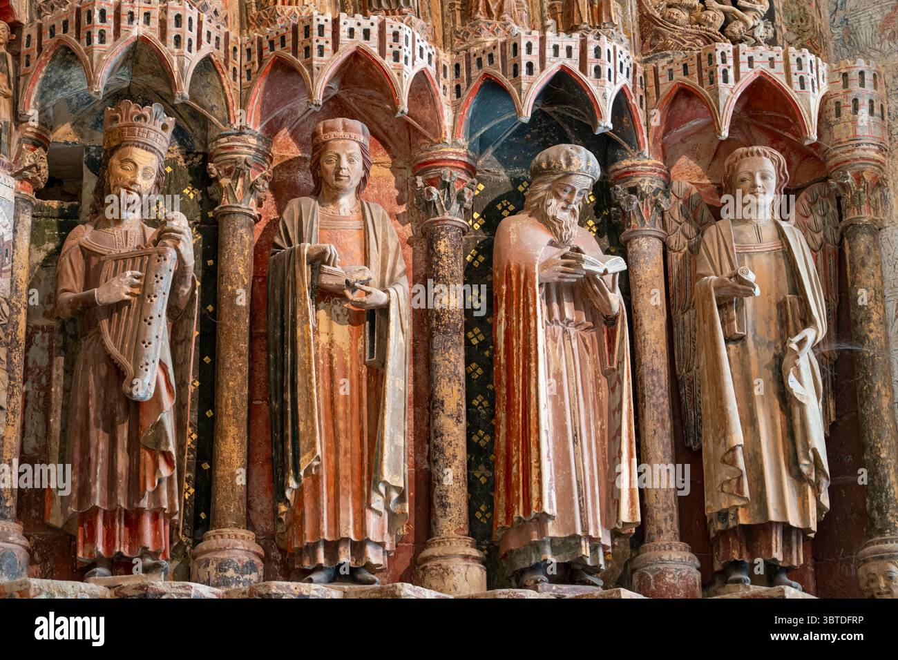 Visitors admire intricate stone sculptures at Colegiata de Santa Maria ...