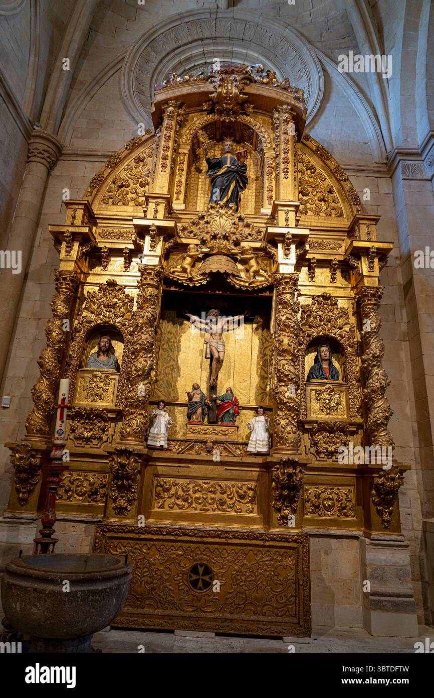 The baroque altar features elaborate golden carvings, religious figures ...
