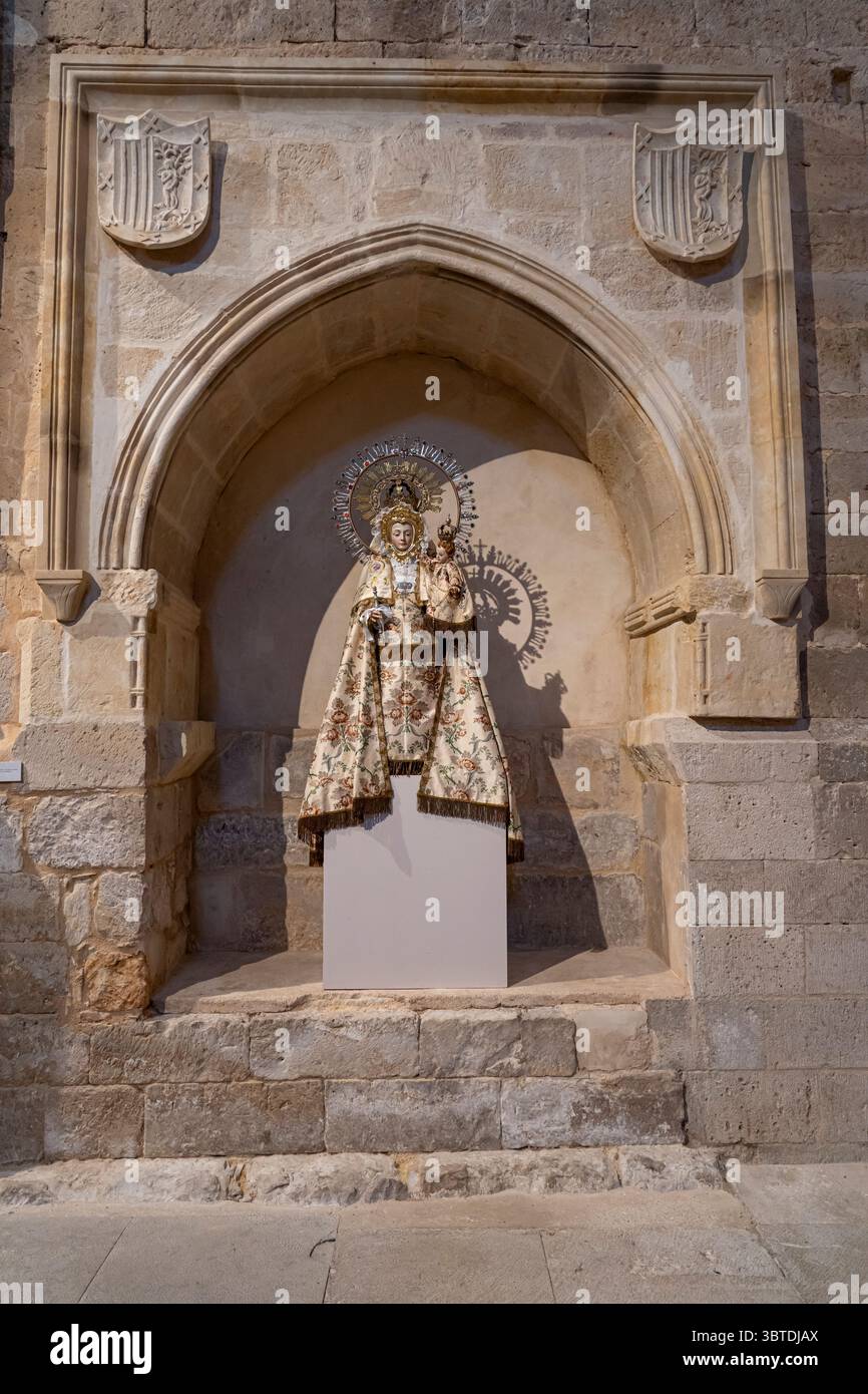 The statue of a revered religious figure stands majestically in a stone ...