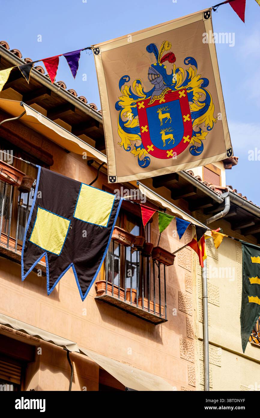 Colorful banners and decorations adorn buildings in Alcala de Henares ...