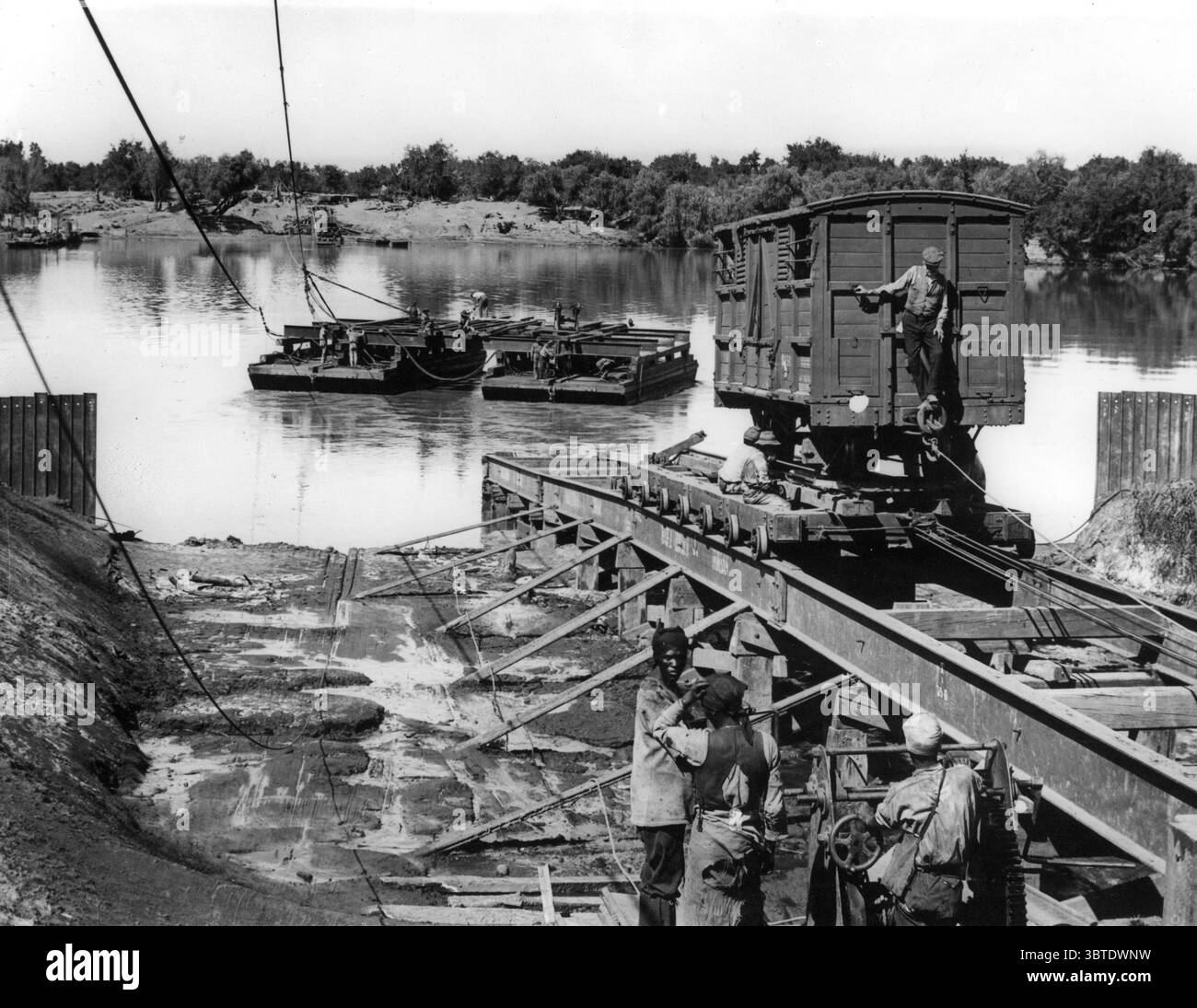 Truck being hauled up the slip at the far side of the Orange River ...