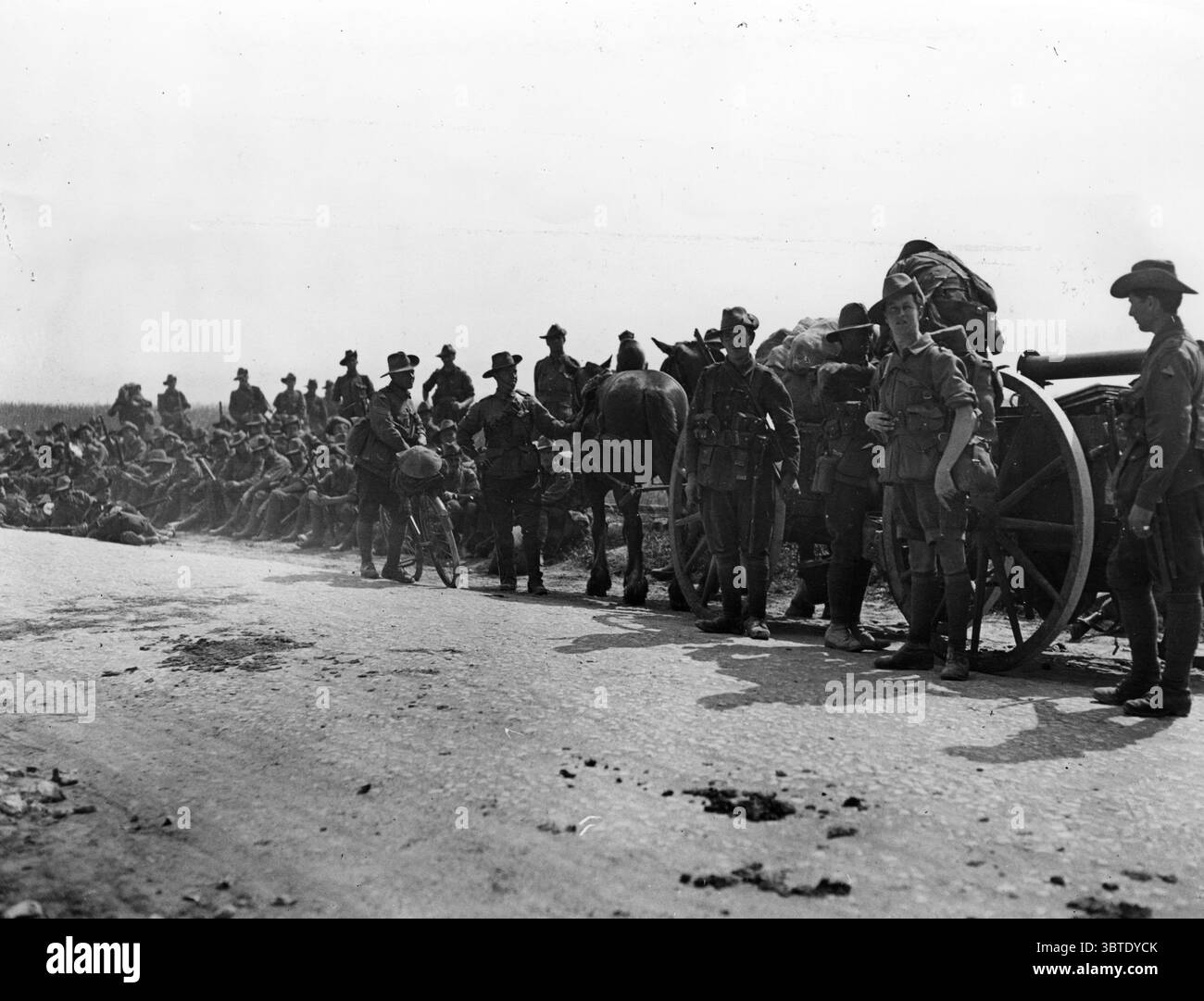 Men of the 2nd Australian Division resting by the roadside during their ...